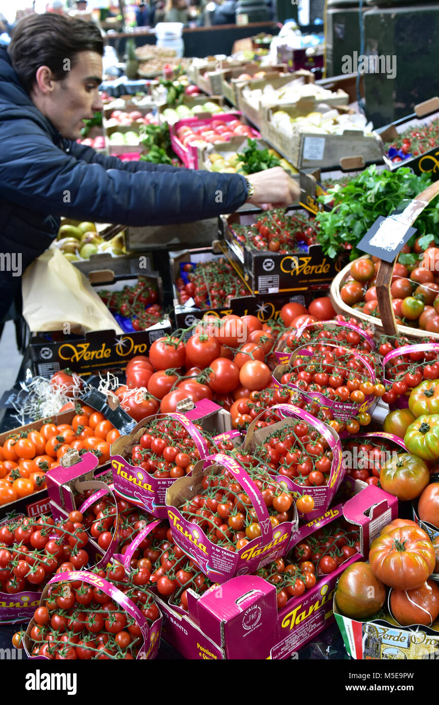 a man selling freshly produces tomatoes at a stall in borough market ...