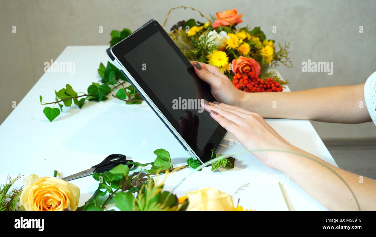 Close-up of tablet on which florist girl's hands lead fingers am Stock ...