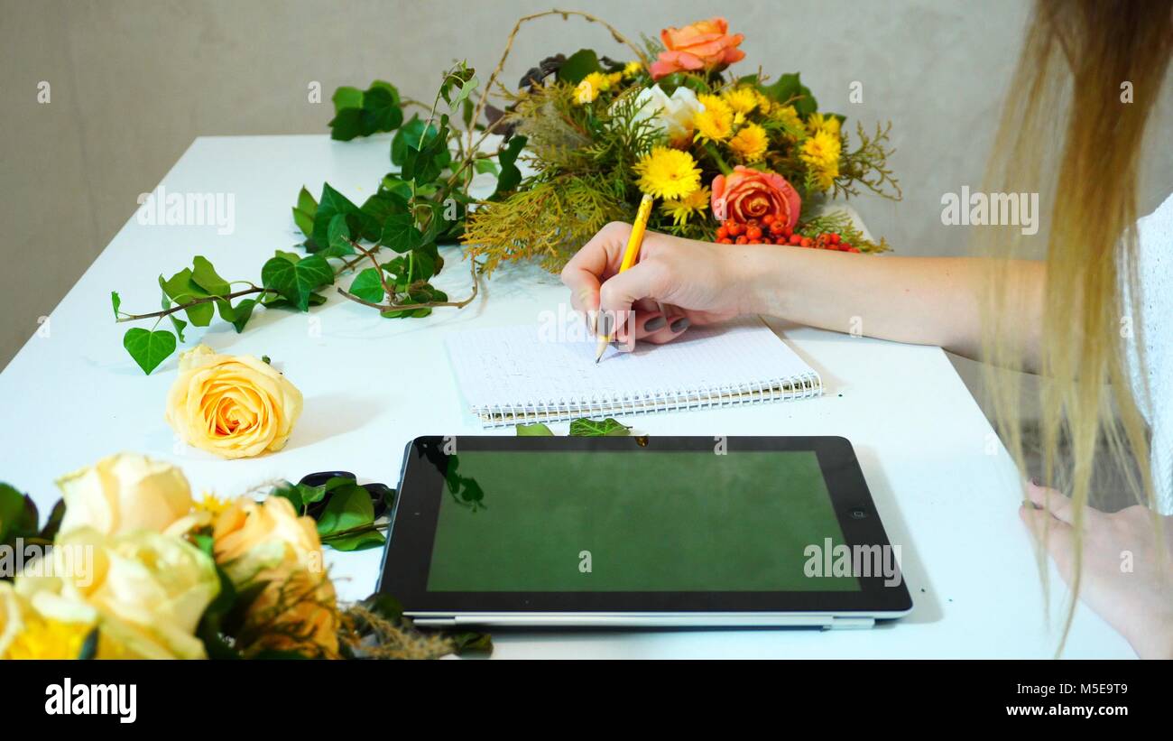 Shooting close-up of hands of female florist with tablet that s Stock ...