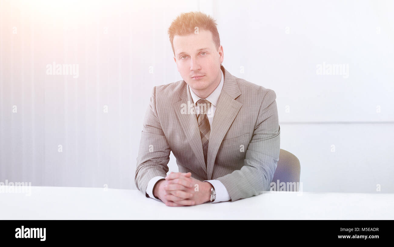 successful businessman sitting behind a Desk Stock Photo - Alamy