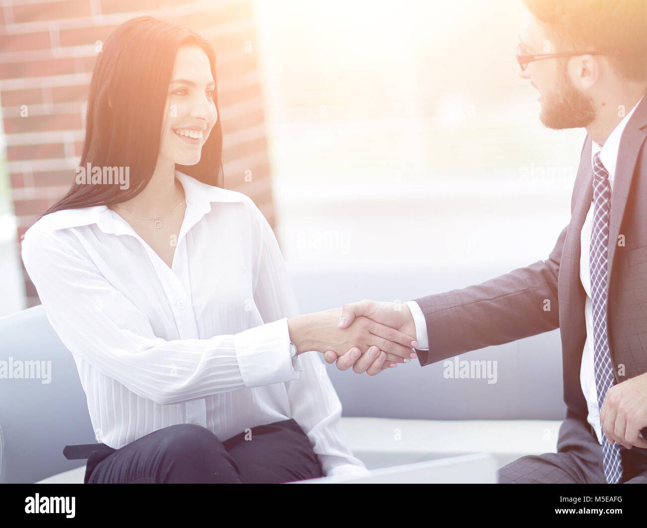 handshake of manager and client sitting in the office lobby Stock Photo ...