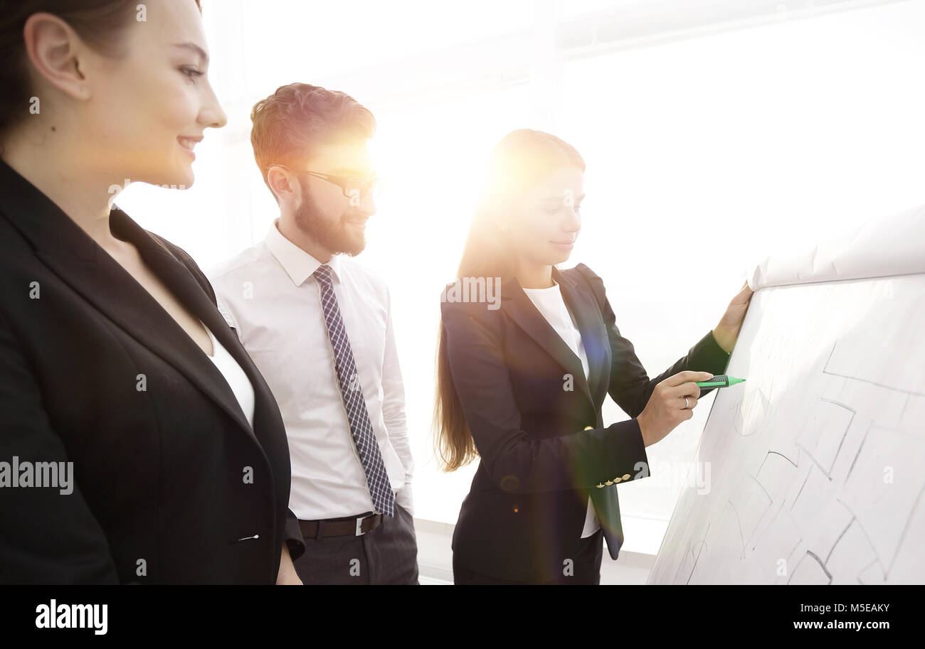 businesswoman pointing marker to flipboard on presentation in office ...