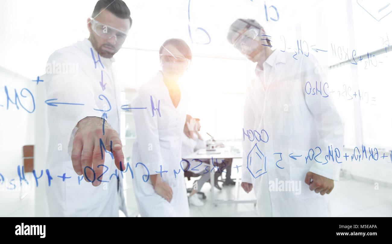 group of laboratory scientists discussing their research in the Stock ...