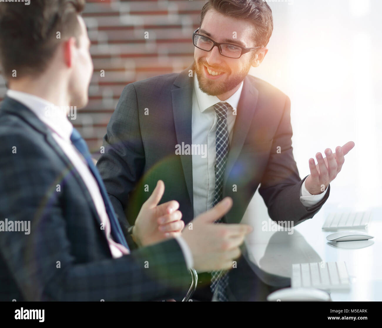 Manager talking with a colleague Stock Photo - Alamy