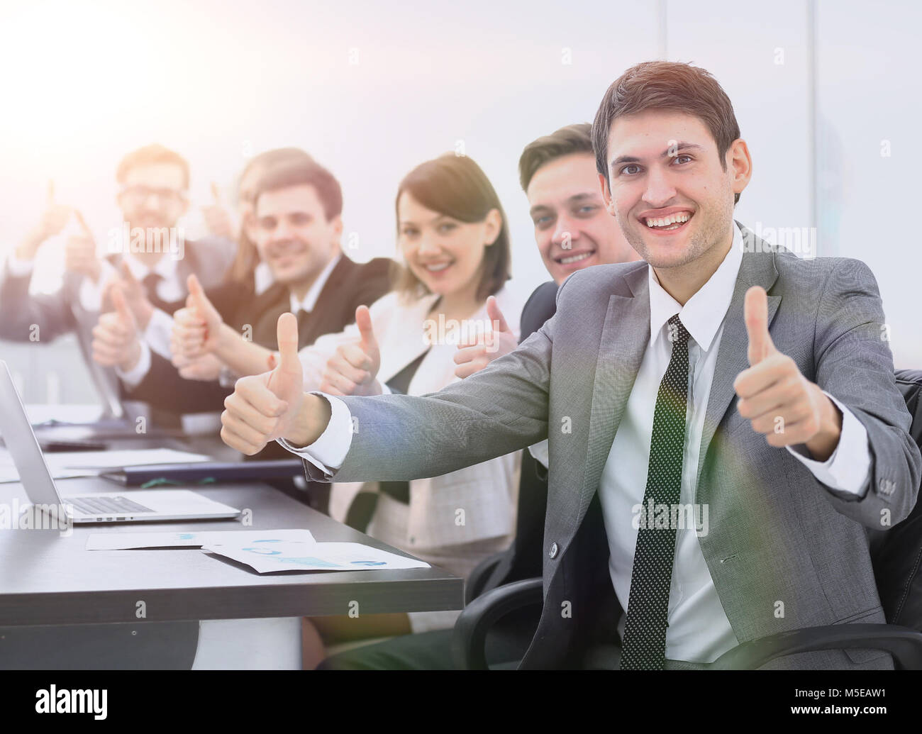 successful business team showing thumbs up Stock Photo - Alamy