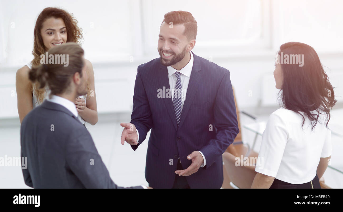 business team talking, standing in office Stock Photo - Alamy