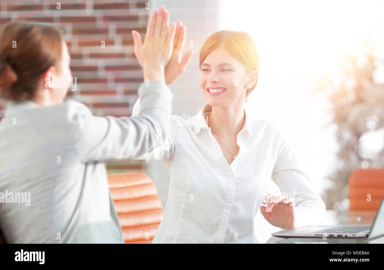members of the business team giving each other a high five Stock Photo ...