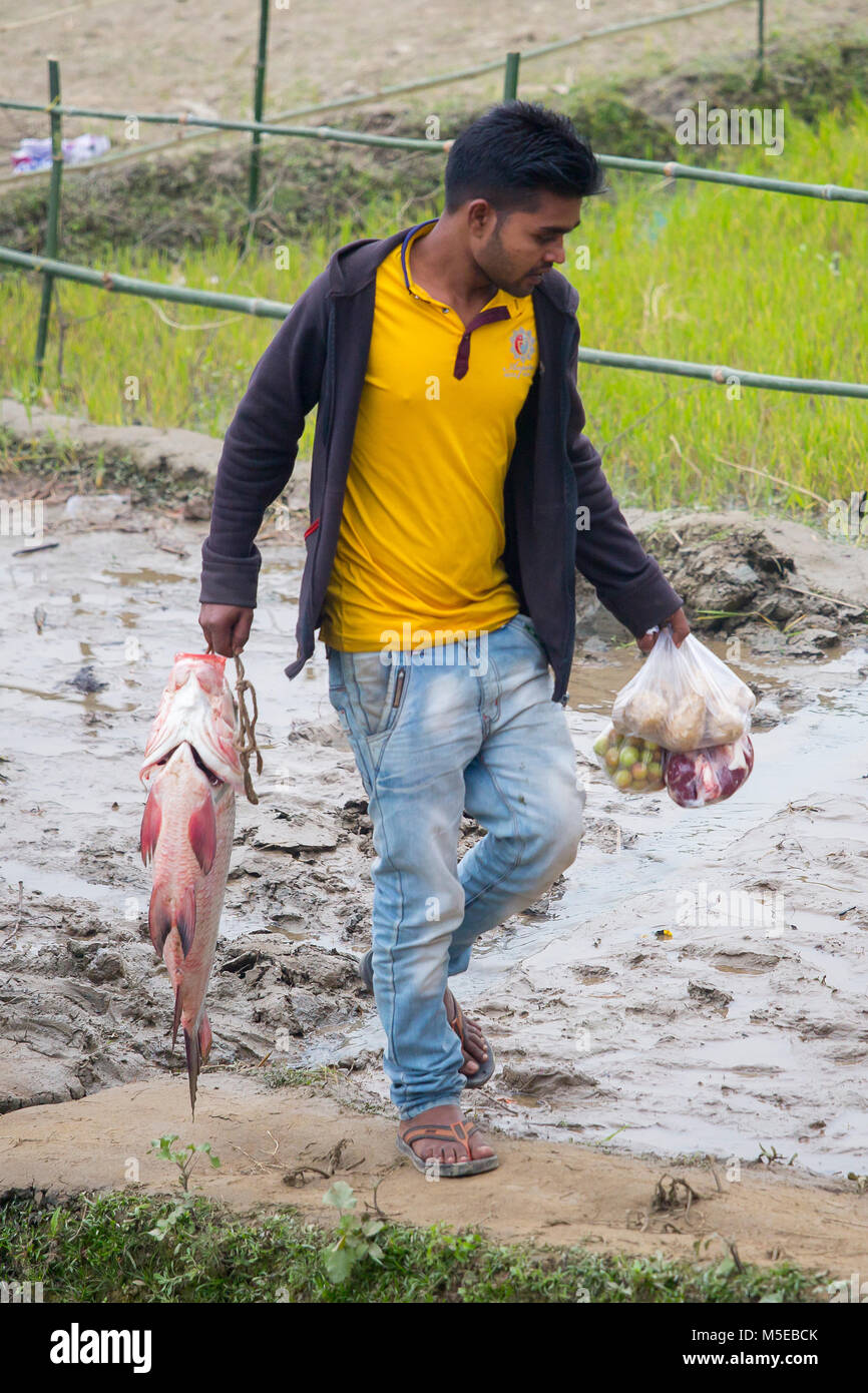 A young boy is returning home after purchasing two fish from the fair ...