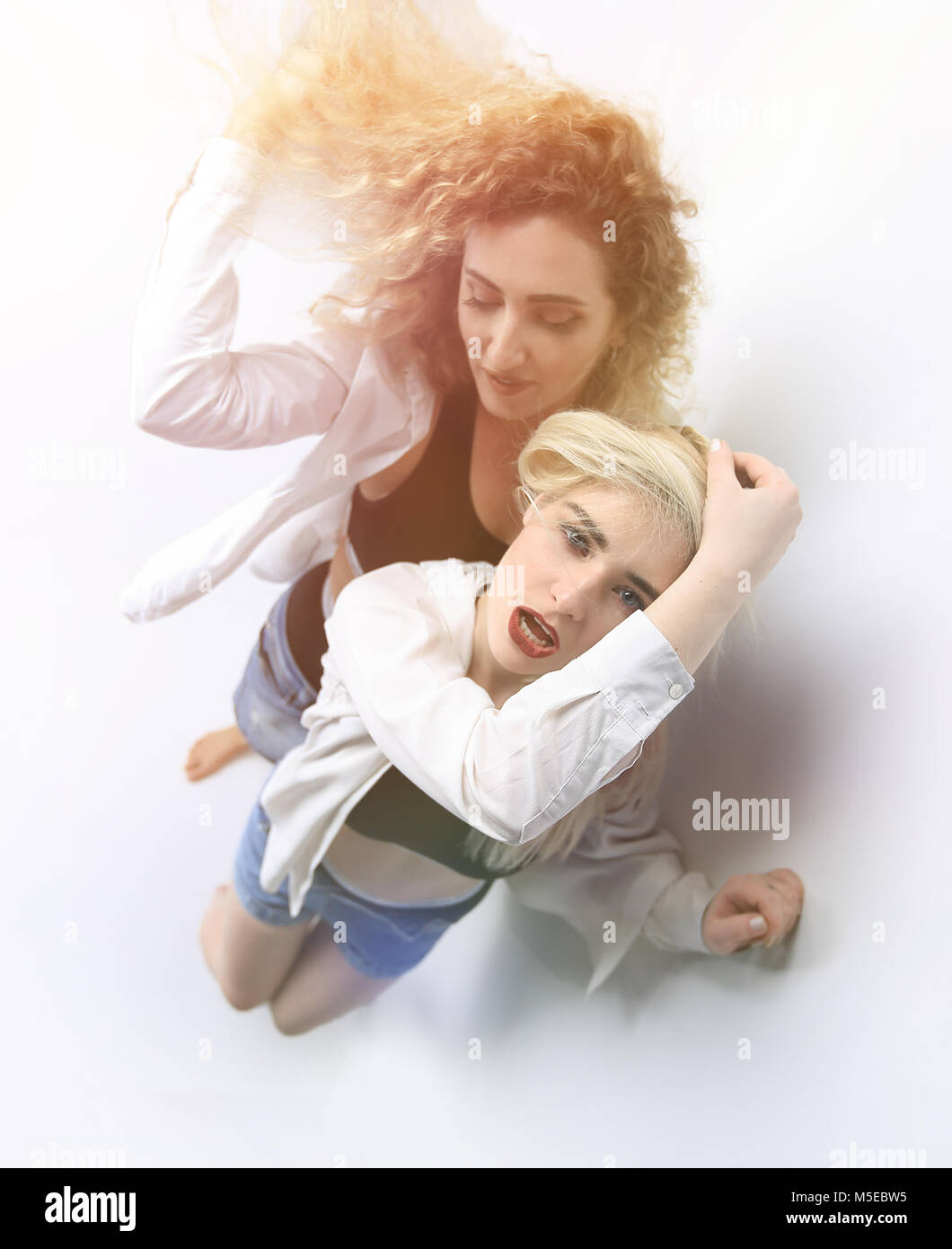 two frustrated women standing near the walls Stock Photo - Alamy