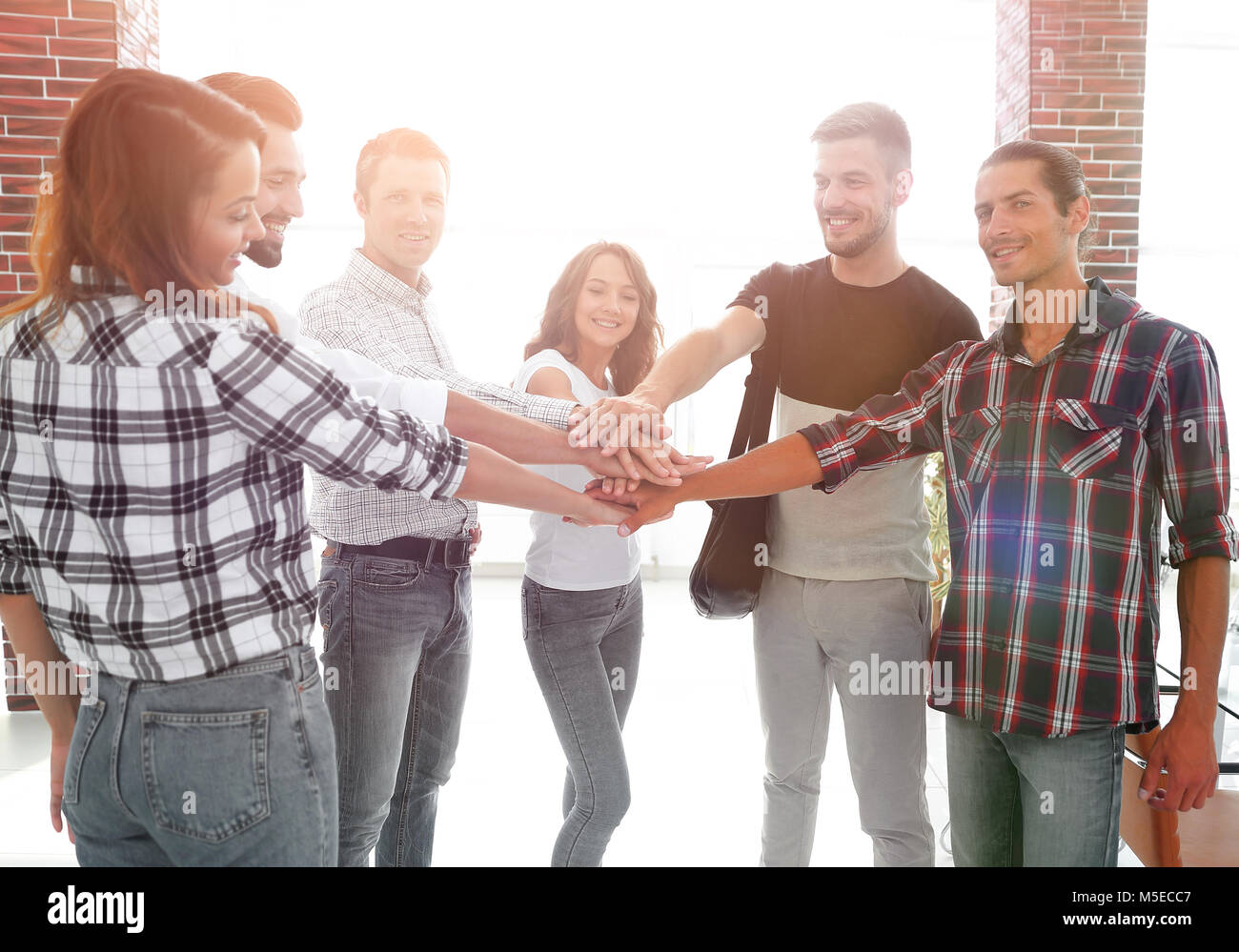 Business Team putting their hands together Stock Photo - Alamy