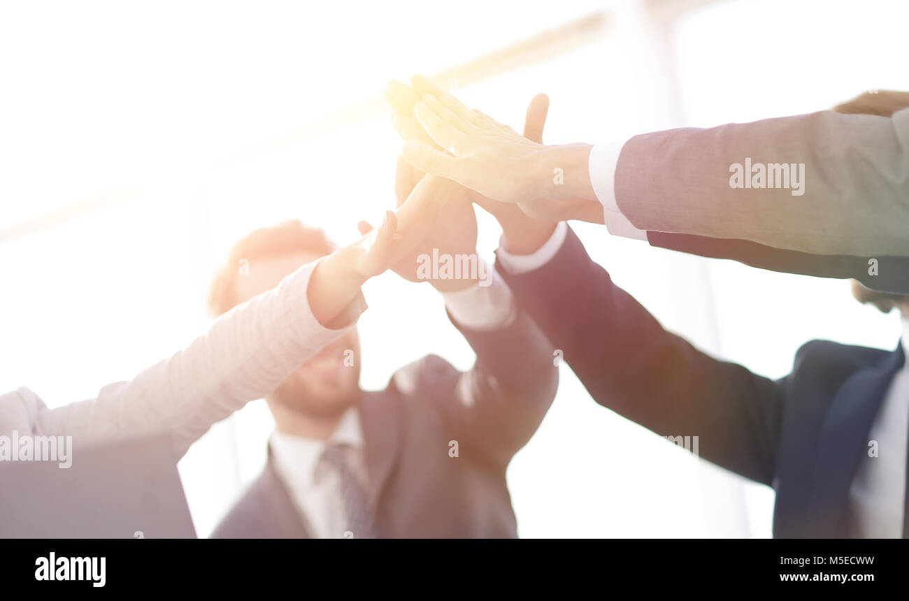 happy business team giving high five in office Stock Photo - Alamy