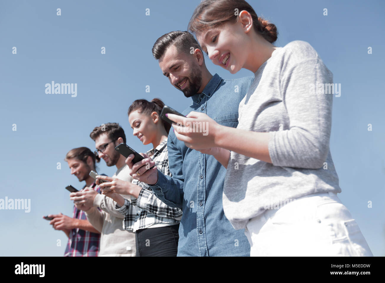 young people using smartphones to search network Stock Photo - Alamy
