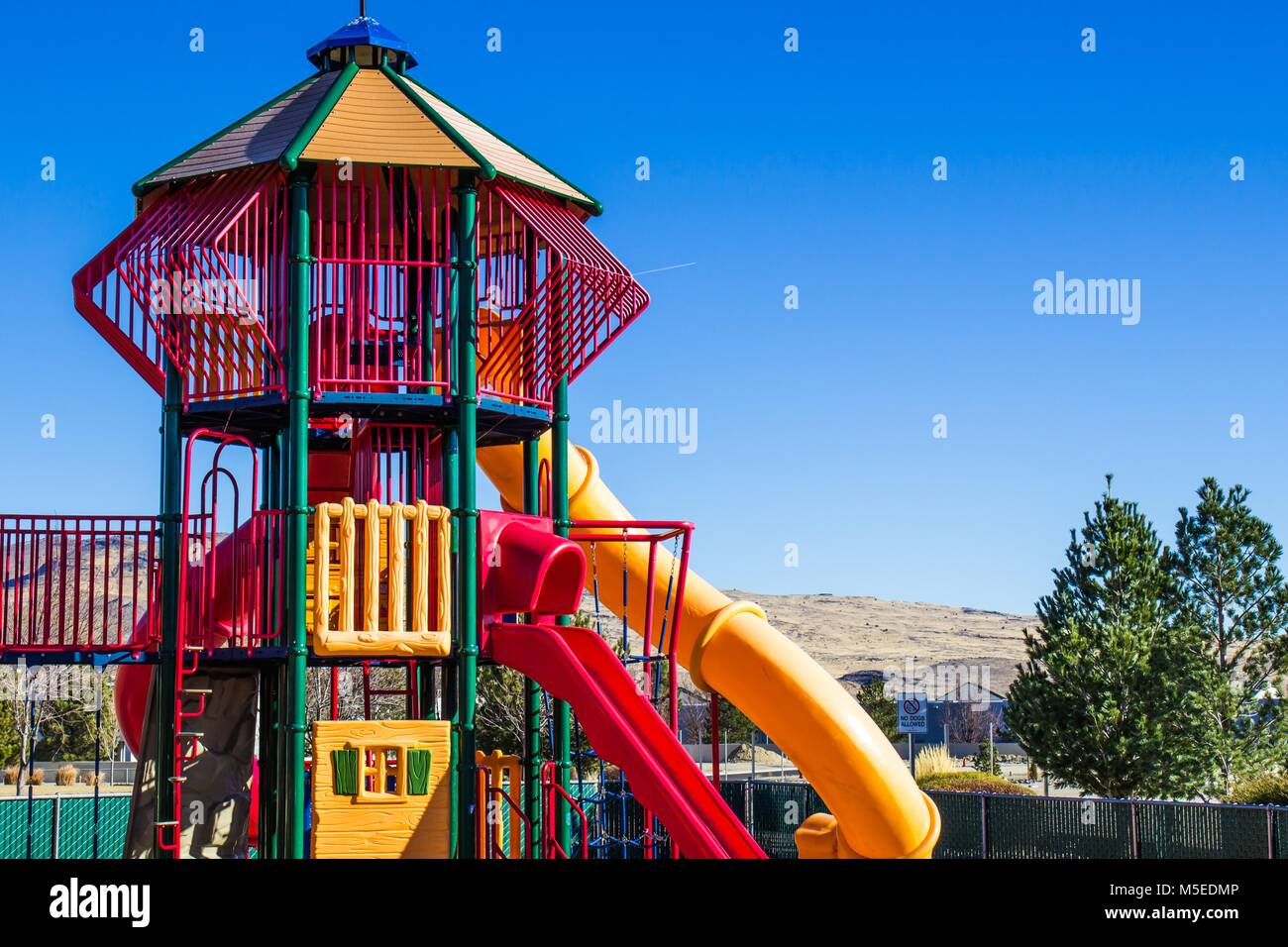 Modern Playground Equipment With Slides & Cage Stock Photo - Alamy