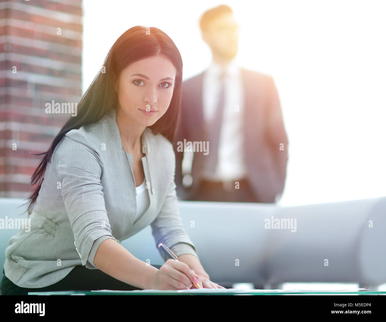 business woman signs documents in a modern office Stock Photo - Alamy
