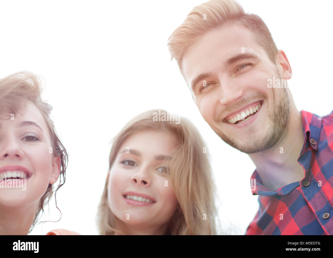 closeup of three young people smiling on white background Stock Photo ...