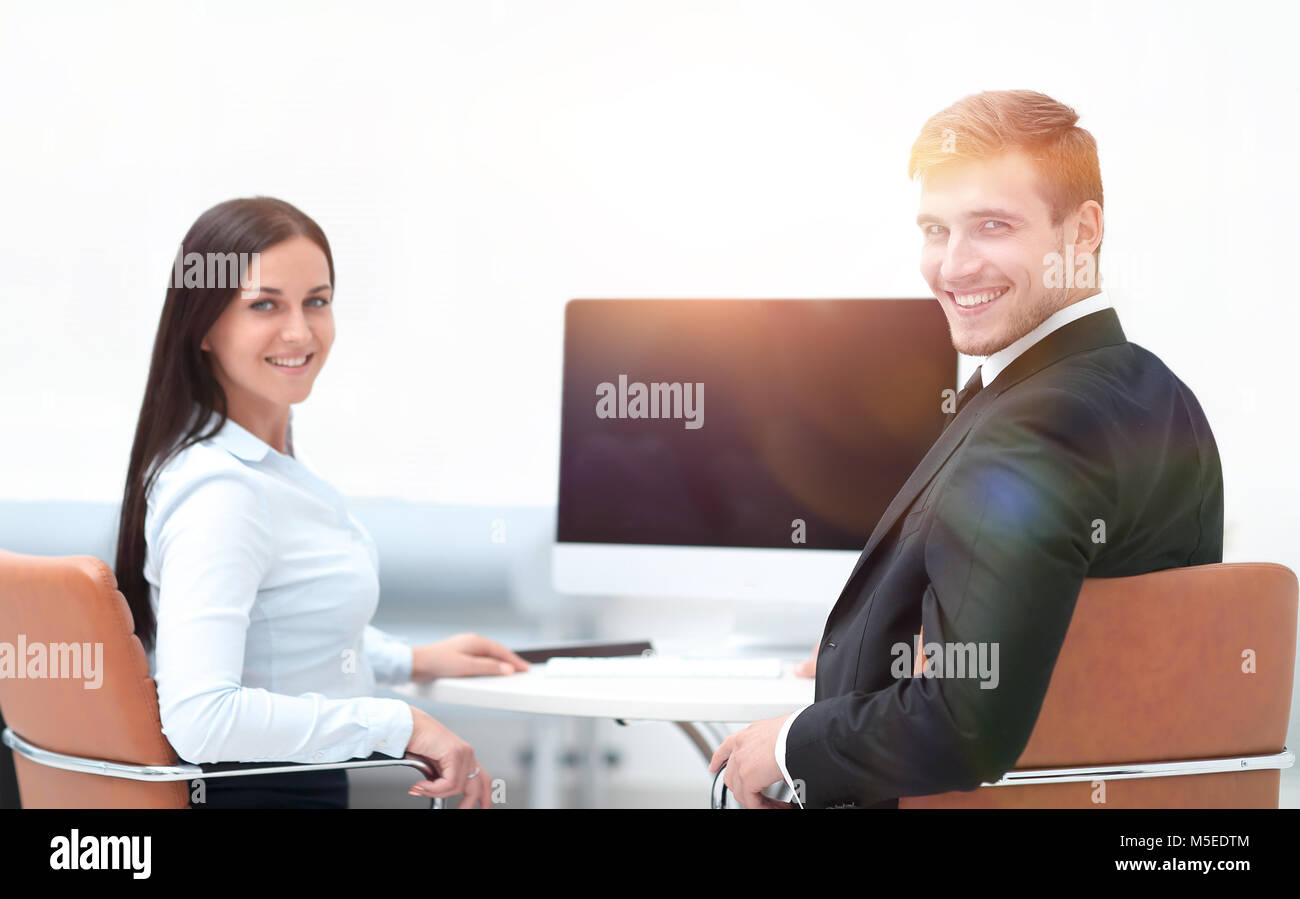 two successful employee sitting behind a Desk Stock Photo - Alamy