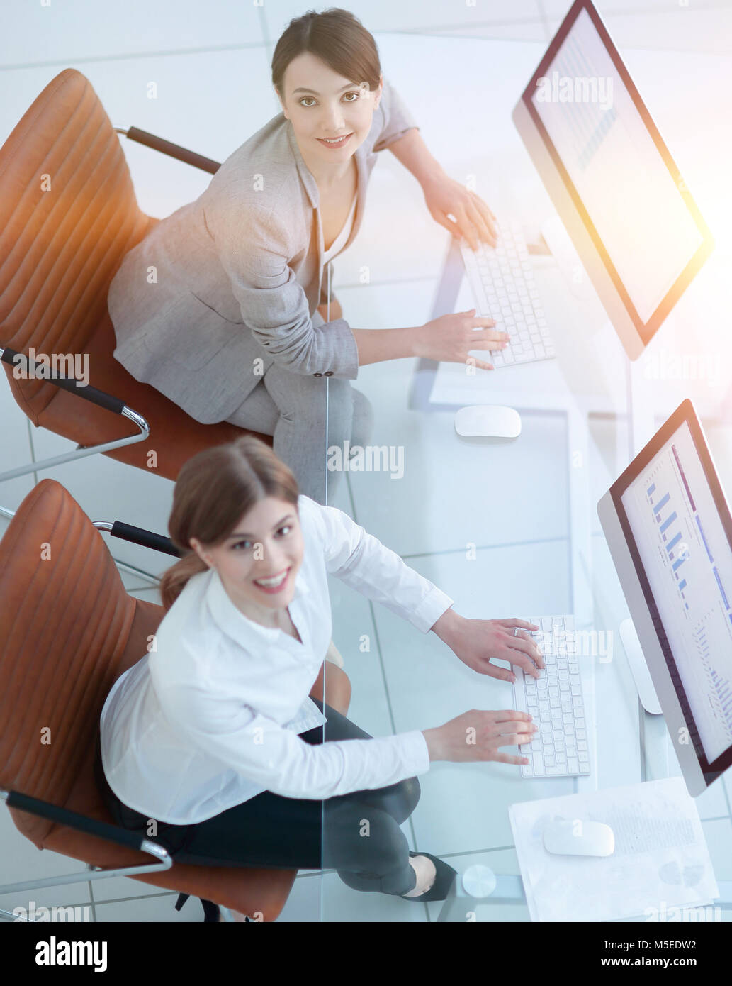 staff of the planning Department sitting behind a Desk and looking at ...