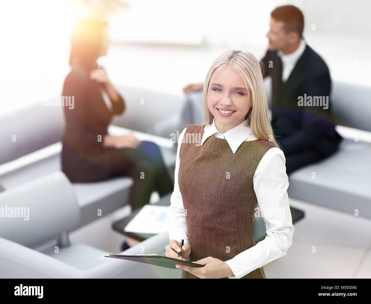 young woman assistant standing in the lobby of the modern office Stock ...