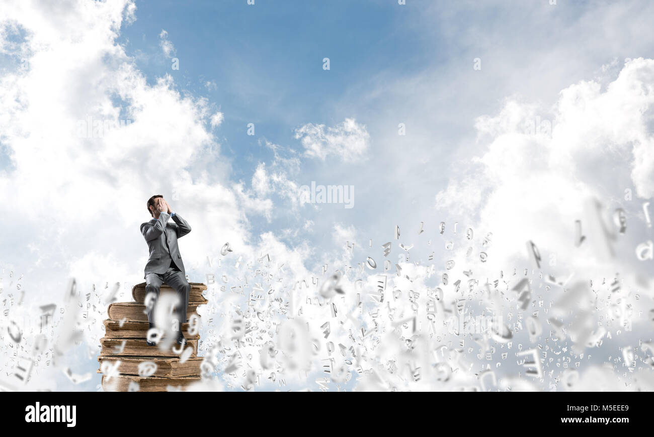 Young man floating in sky and do not want to see anything Stock Photo ...