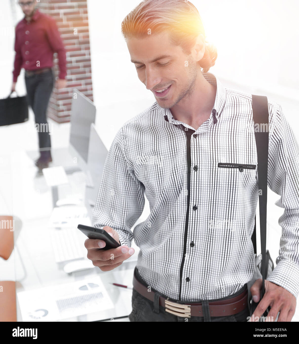 employee reads a text message on smartphone Stock Photo - Alamy