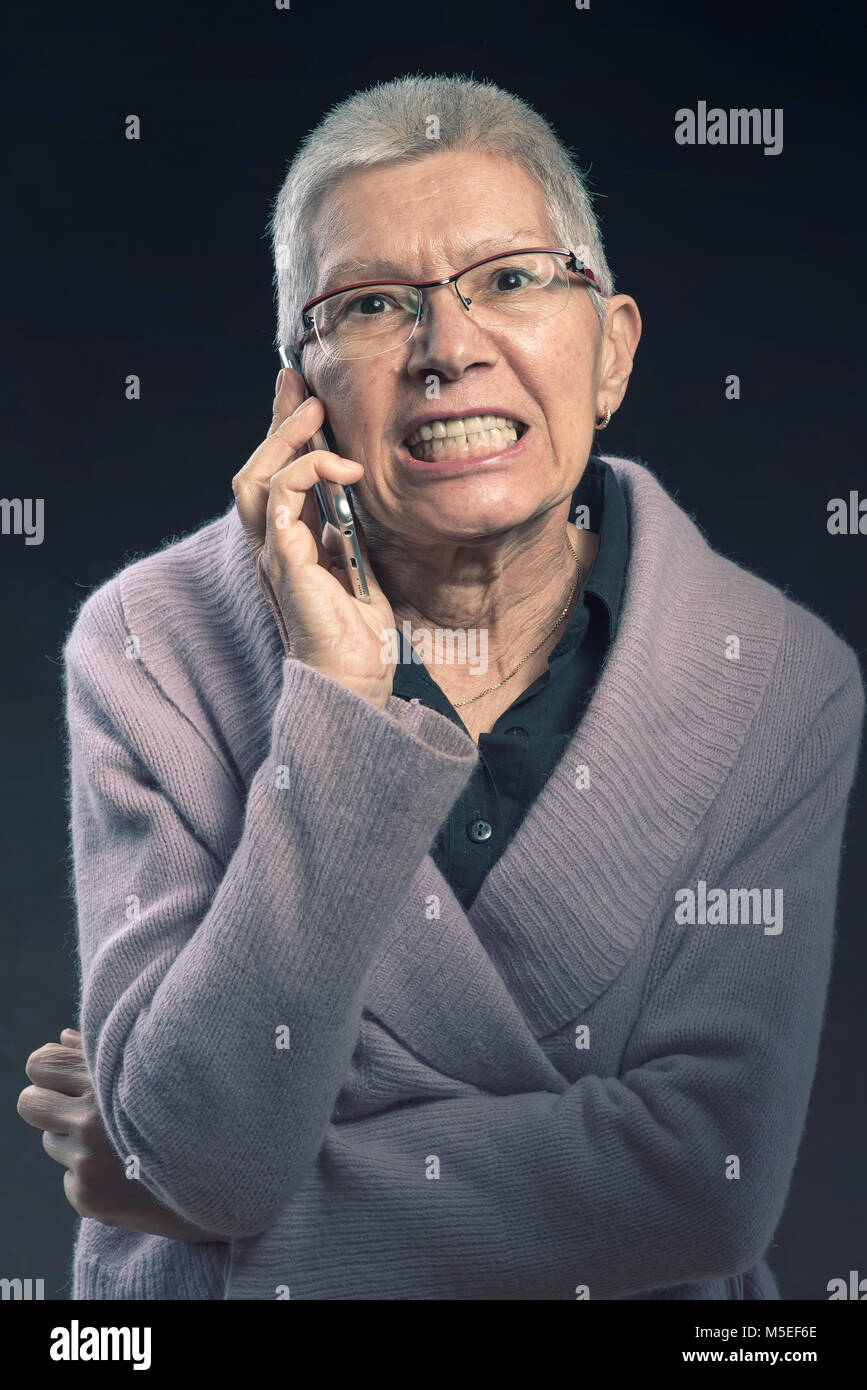 Senior woman on phone angry hi-res stock photography and images - Alamy