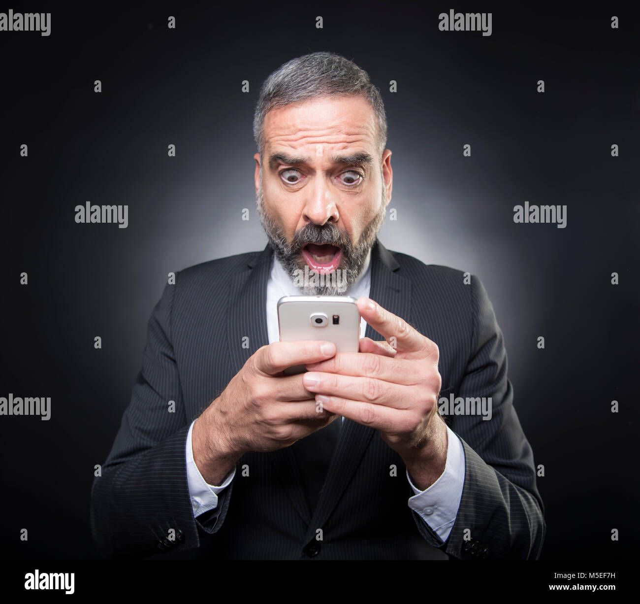 Older man shocked mobile phone hi-res stock photography and images - Alamy