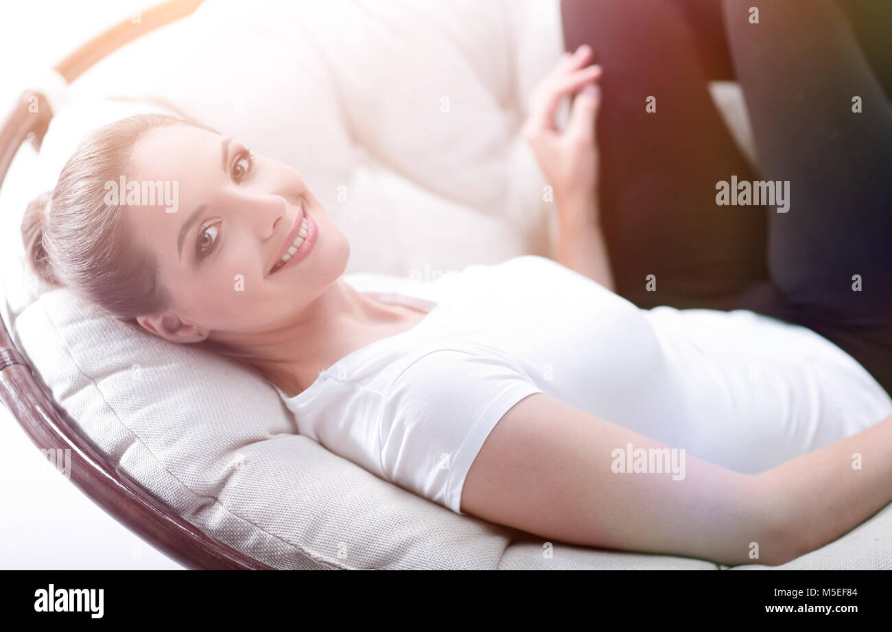 tired woman resting in an easy chair made of rattan Stock Photo - Alamy