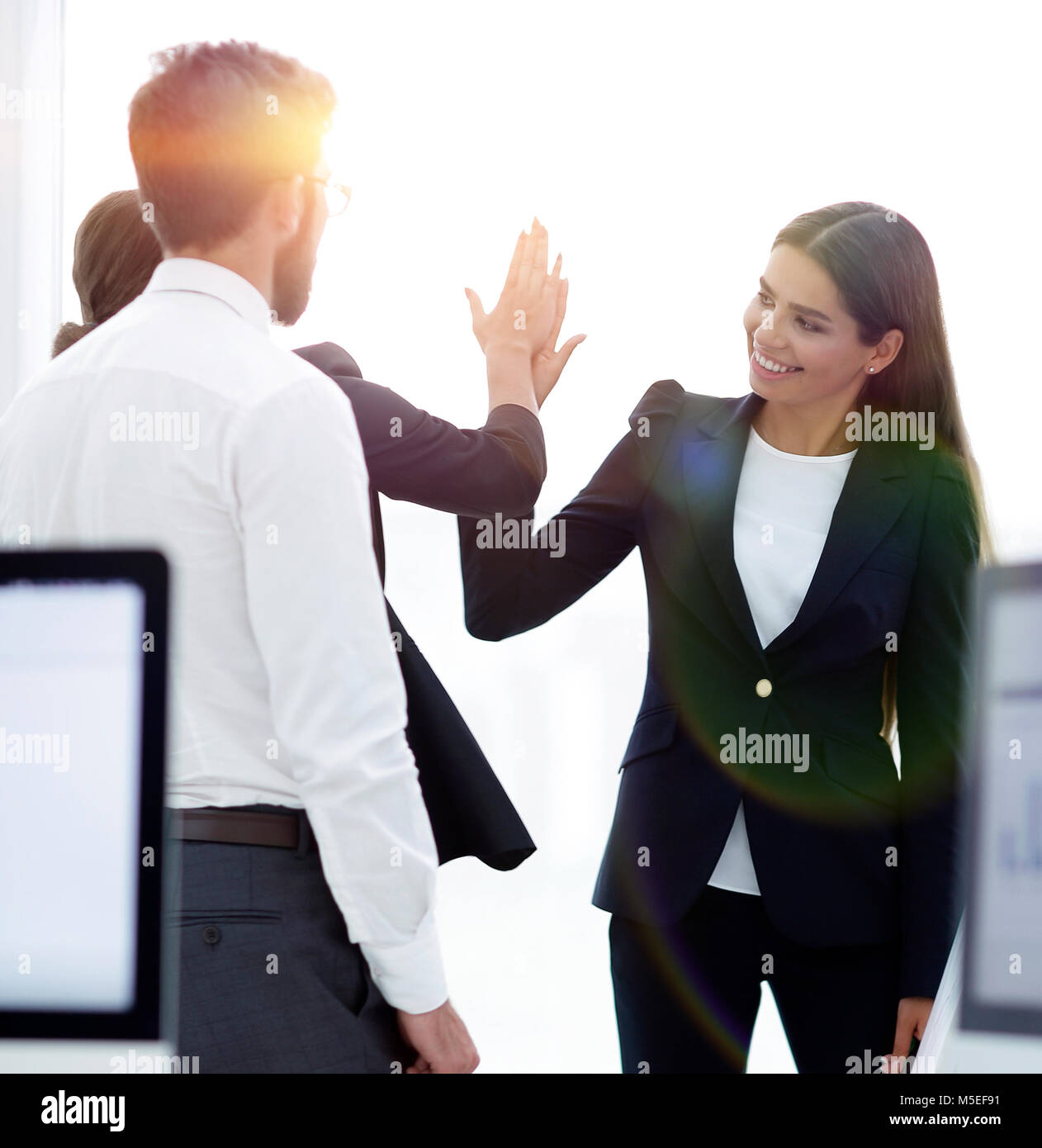 employees giving each other high five Stock Photo - Alamy