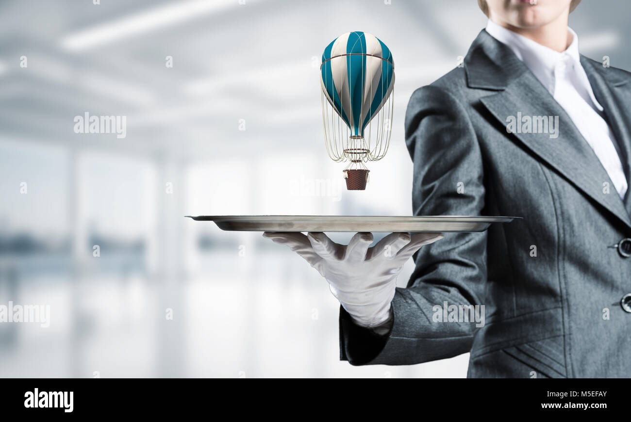 Hand of waiter presenting balloon on tray Stock Photo - Alamy