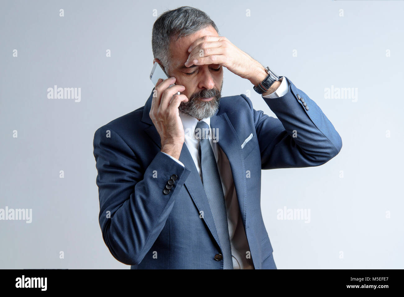 Worried senior business man has a very stressful conversation on his ...