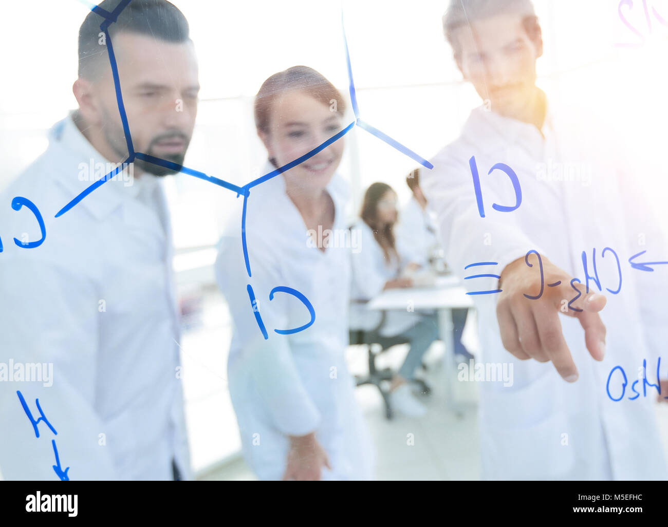 group of laboratory scientists discussing their research in the Stock ...