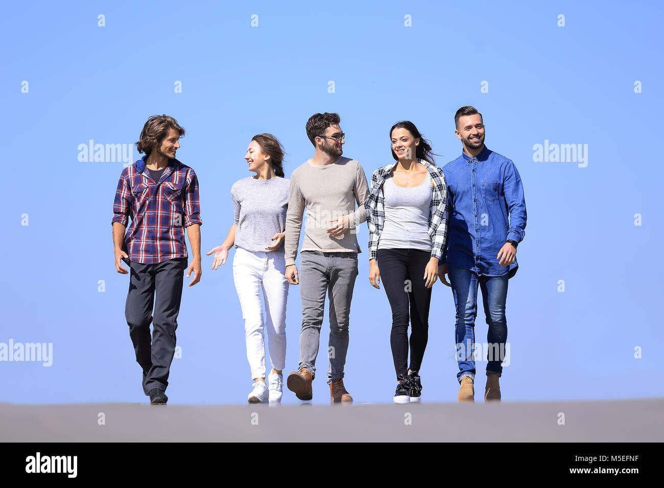 team of young people walking along the road.outdoors Stock Photo - Alamy