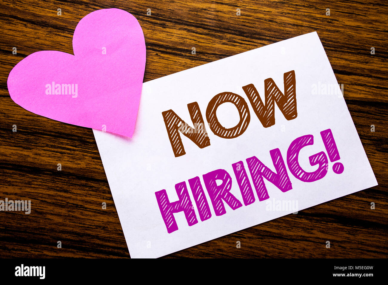 Now hiring written on Sticky Note Message wooden background Stock Photo ...