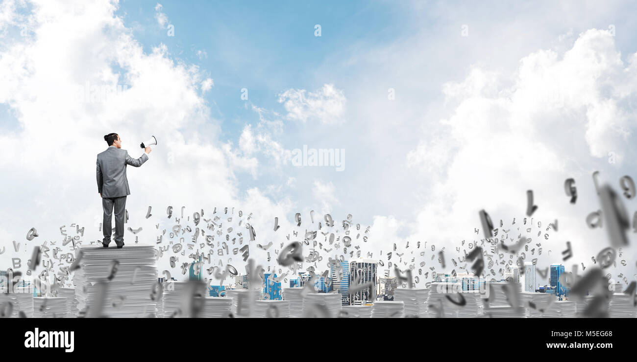 Businessman standing with megaphone Stock Photo - Alamy