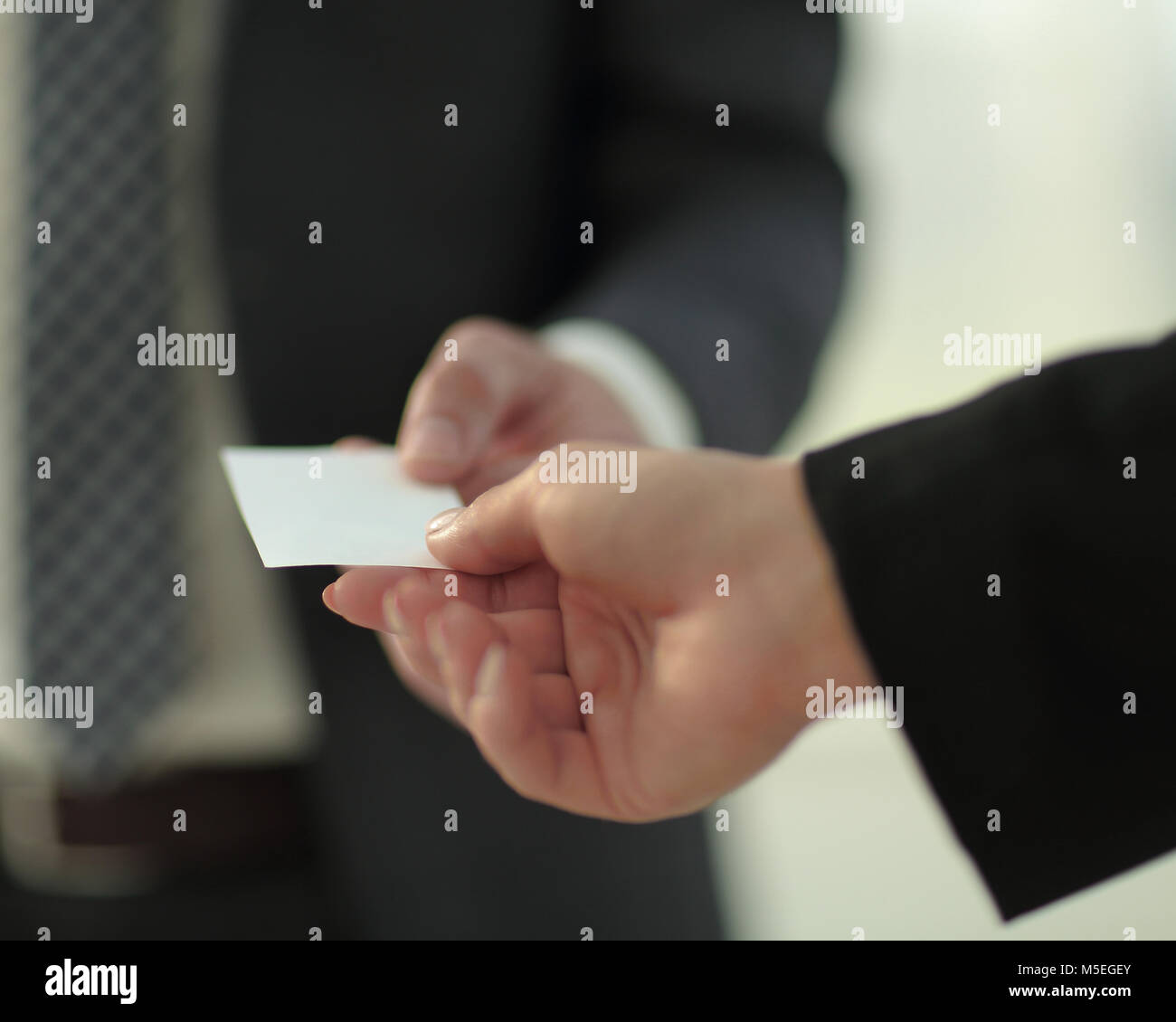 Exchange business card for first time meet Stock Photo - Alamy