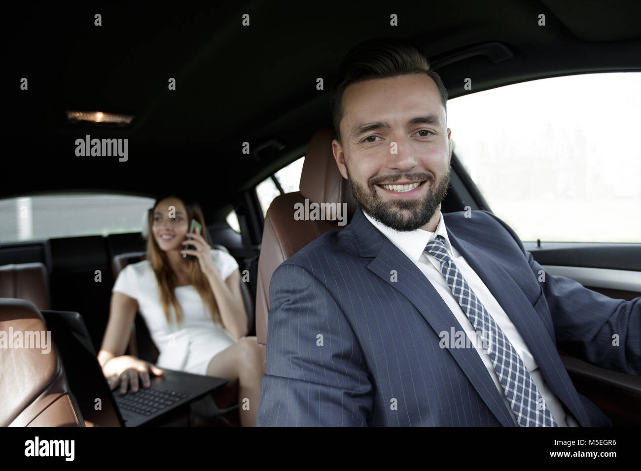 Attractive elegant serious man drives good car Stock Photo - Alamy