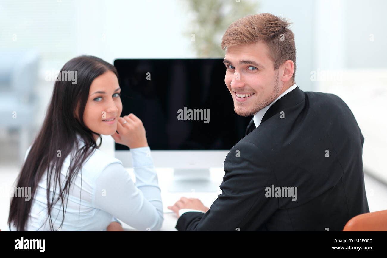 two successful employee sitting behind a Desk Stock Photo - Alamy