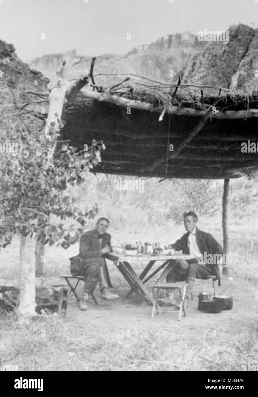 Grand Canyon Historic - Rust Camp c 2 MEN SEATED AT SET TABLE UNDER THE ...