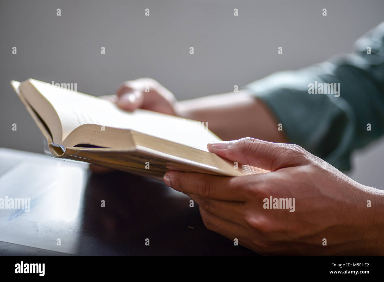 Closeup hand open book for reading concept background Stock Photo - Alamy