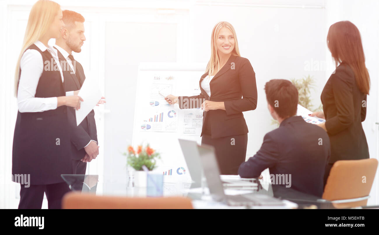 business woman pointing a pointer on a flipchart Stock Photo - Alamy