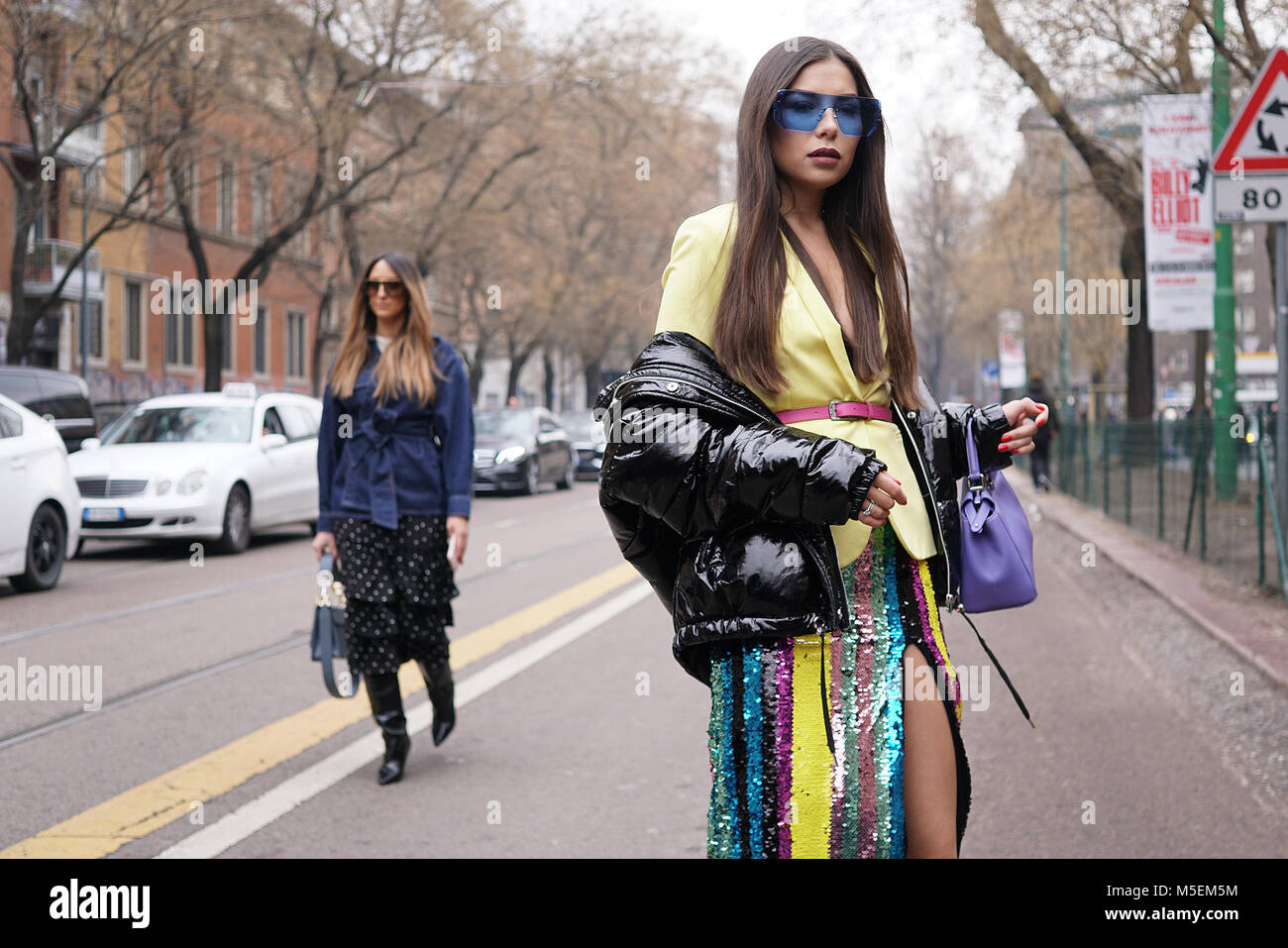 Milan, Italy - February 22, 2018: Girl with fashionable outfit posing ...