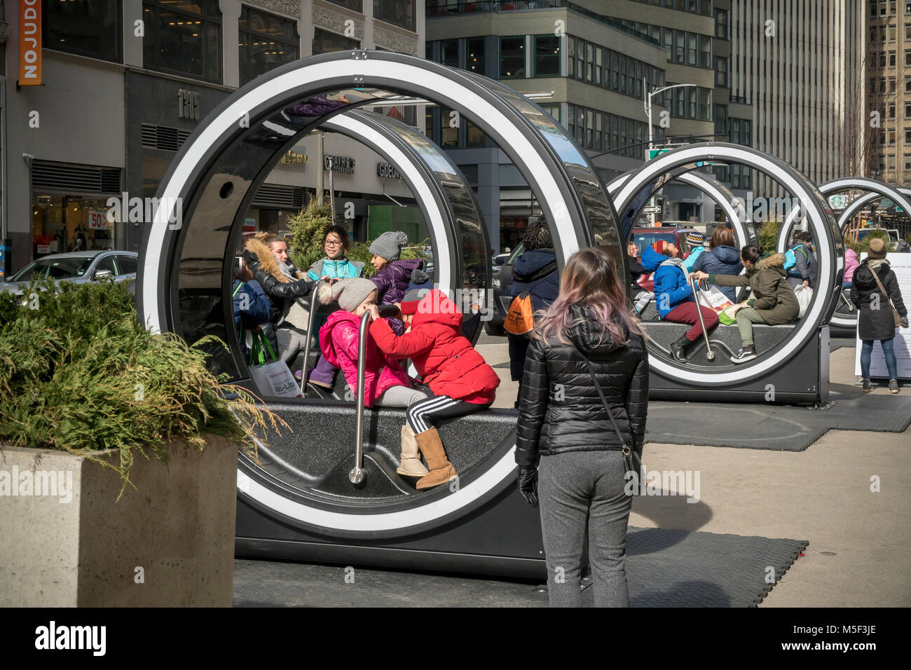 Visitors to the Garment District in New York amuse themselves with the ...