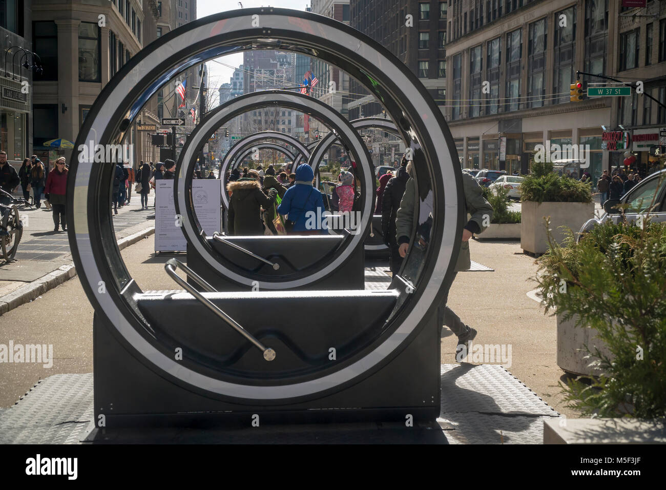 Visitors to the Garment District in New York amuse themselves with the ...