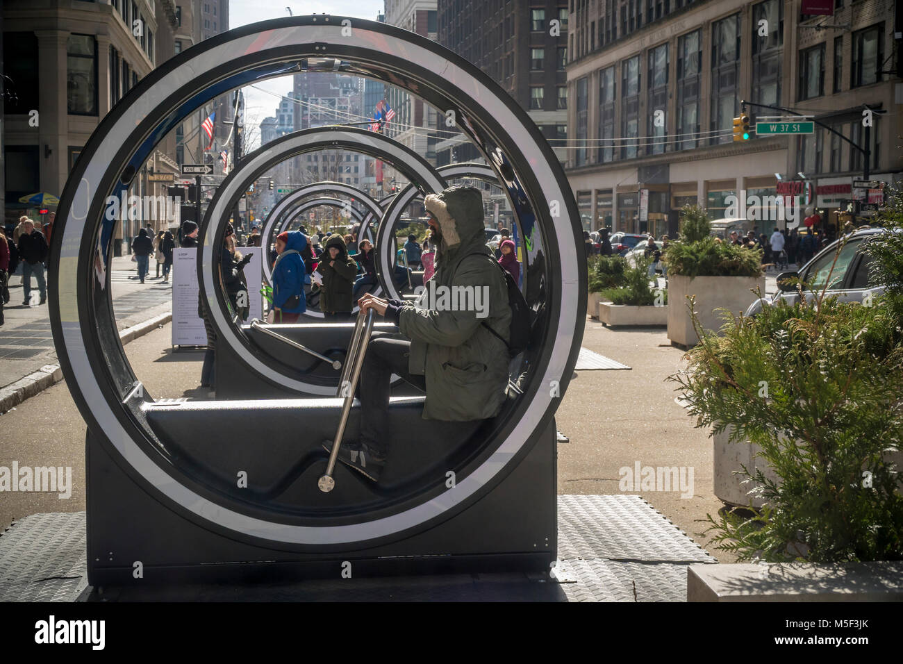 Visitors to the Garment District in New York amuse themselves with the ...
