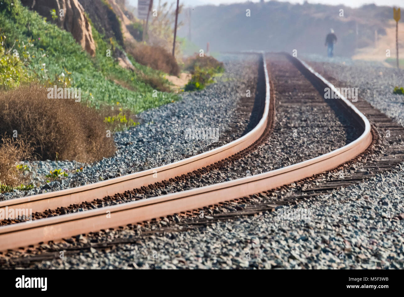 railroad train tracks on curve Stock Photo - Alamy