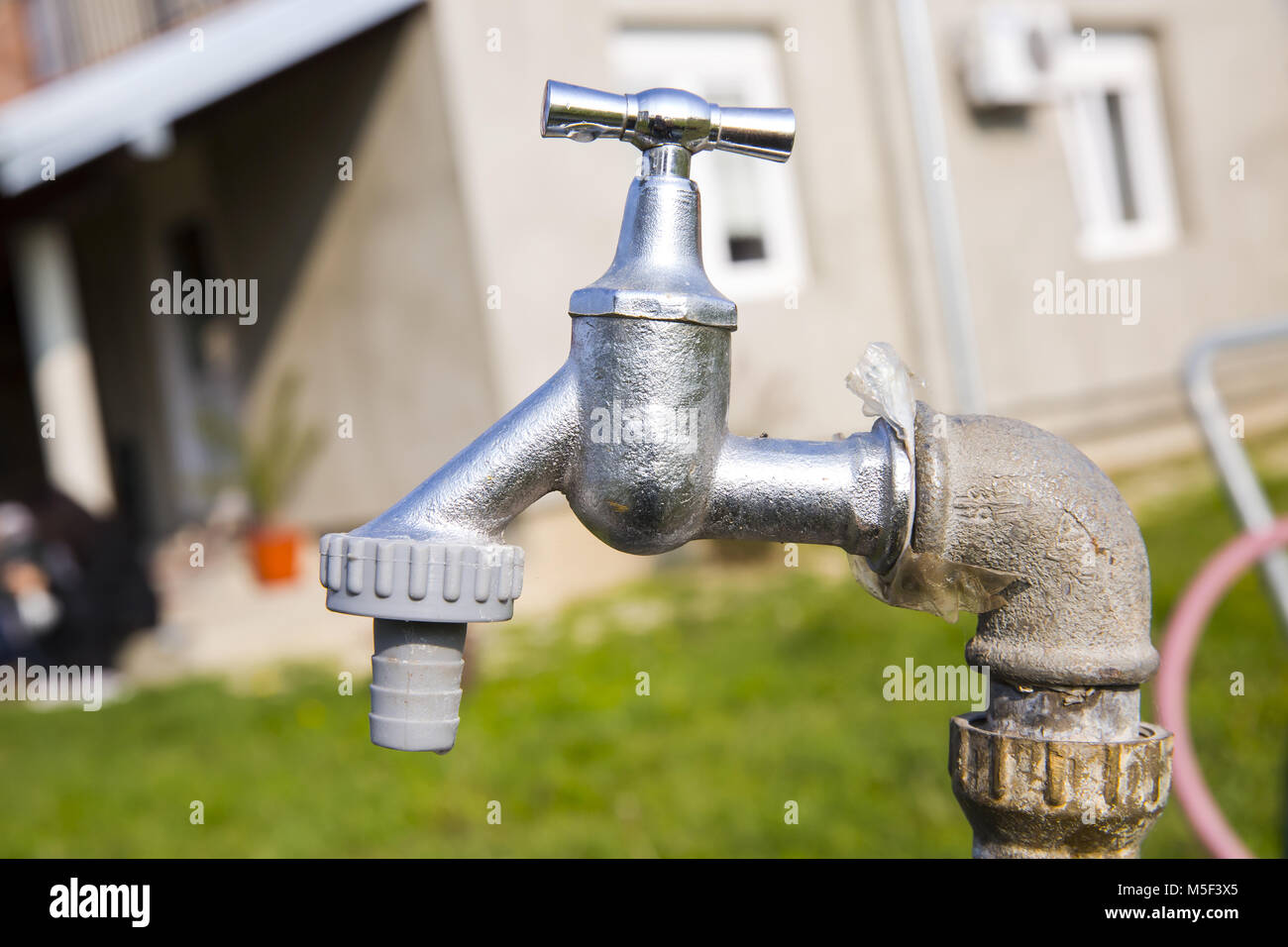 Wasting water - water drop from water tap Stock Photo - Alamy