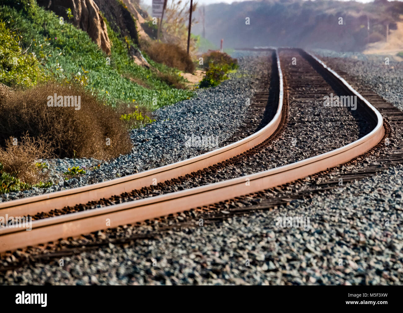 railroad train tracks on curve Stock Photo - Alamy