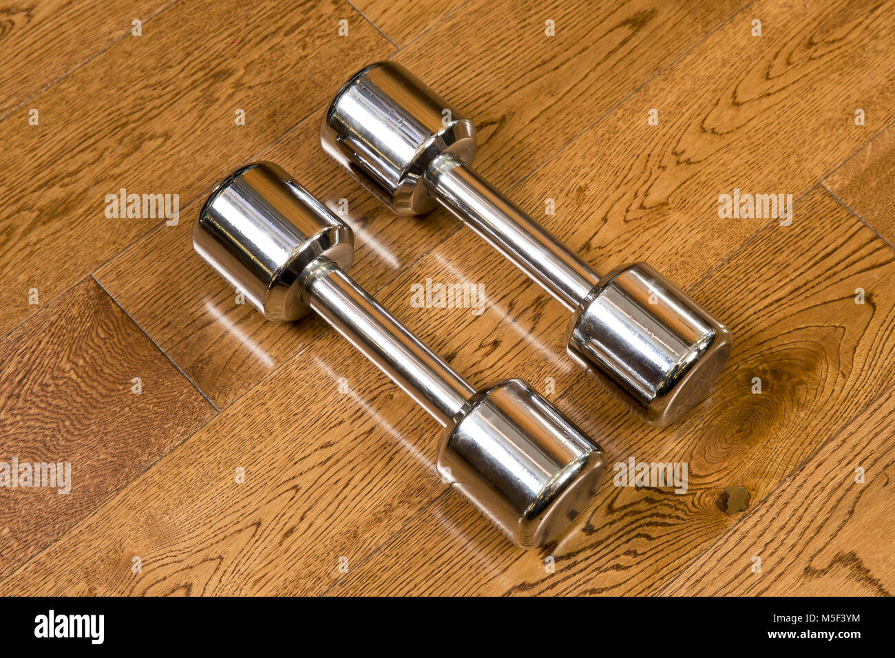 silver colored dumbbells Stock Photo - Alamy