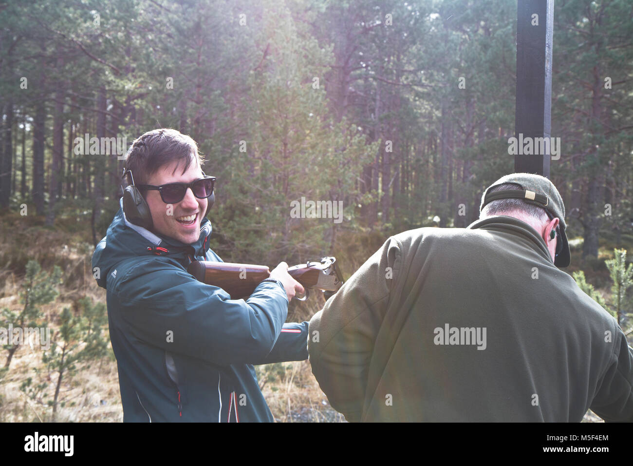 Clay Pigeon shooting in a forest (with a Shot gun) on a sunny day out ...