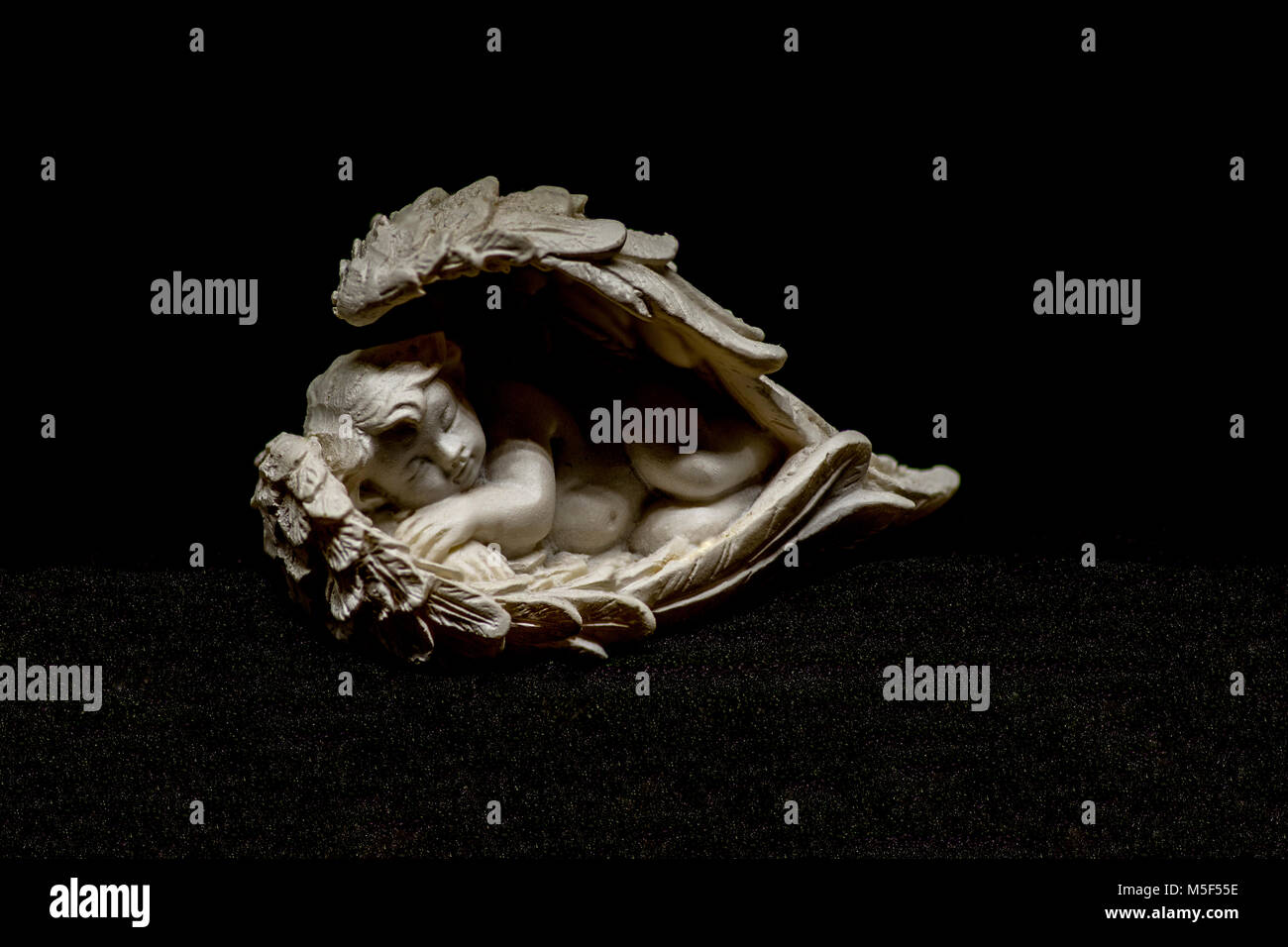 little angel is sleeping inside his wings Stock Photo - Alamy